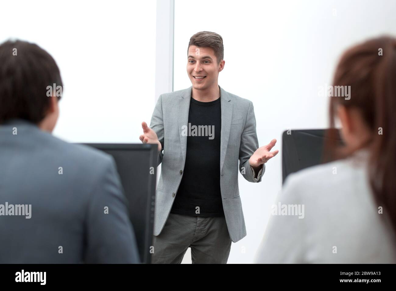 young businessman explaining something to the office staff Stock Photo ...