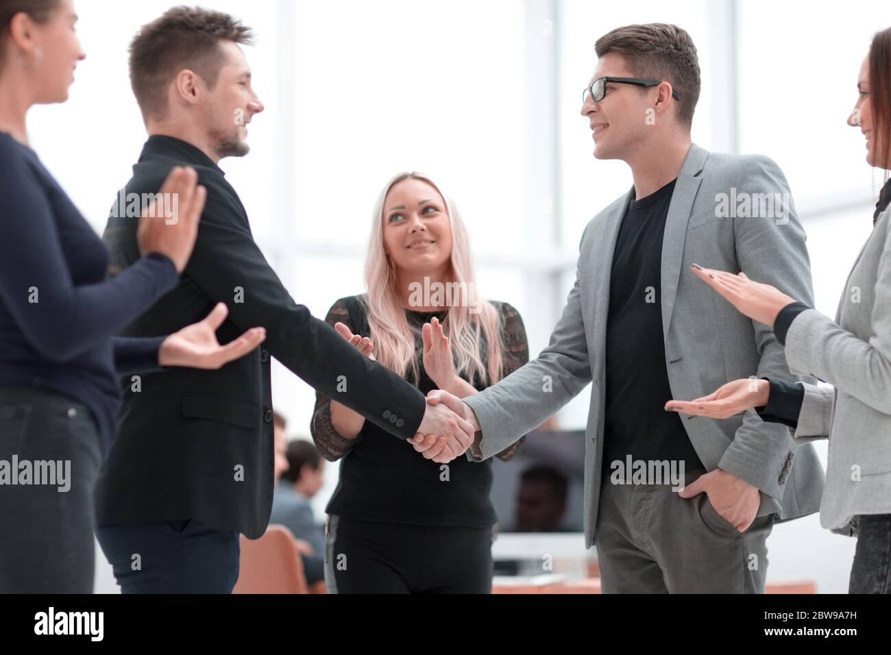 happy business partners confirming the transaction with a handshake ...