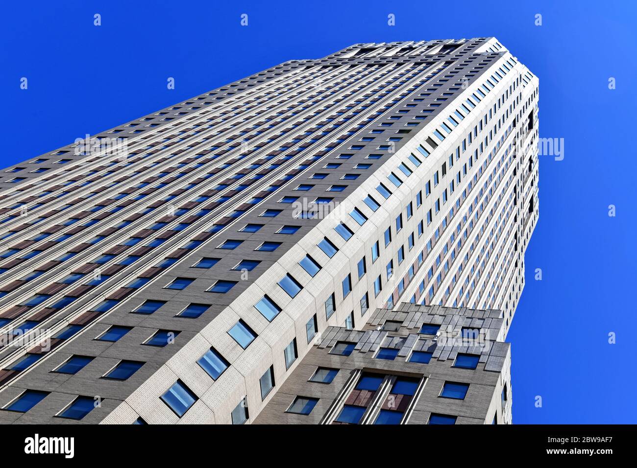 Tall high rise skyscraper with blue sky in Manhattan New York Stock ...
