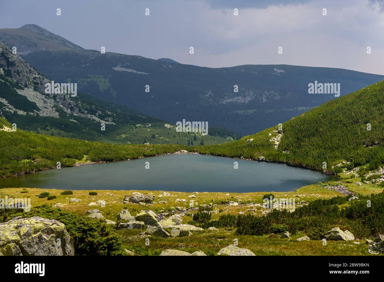 Triangle shaped glacier lake in Retezat Mountains, Romania, surrounded ...