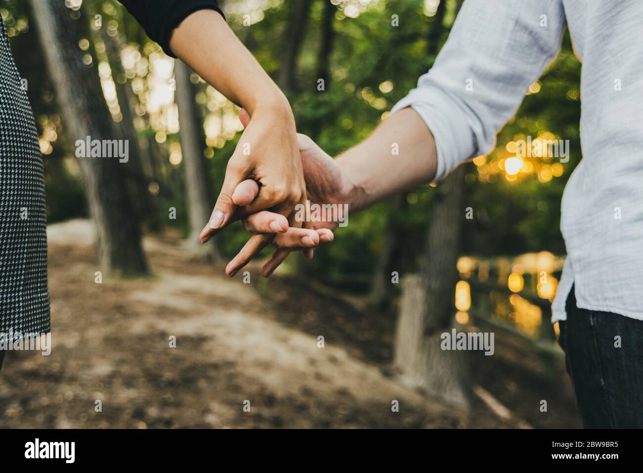 Intertwined hands young couple hi-res stock photography and images - Alamy