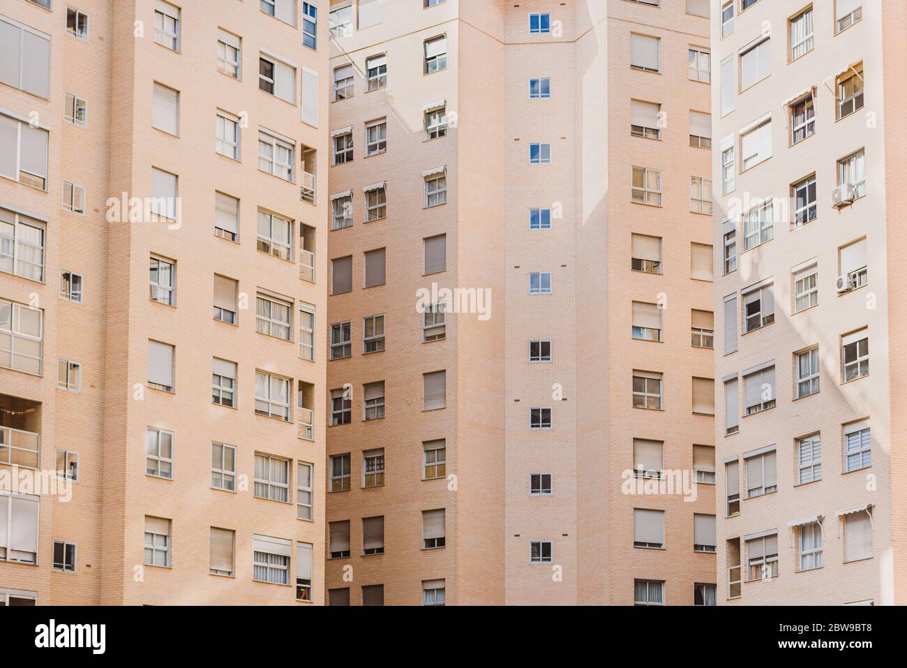 Overcrowded brick buildings with clean square windows Stock Photo - Alamy
