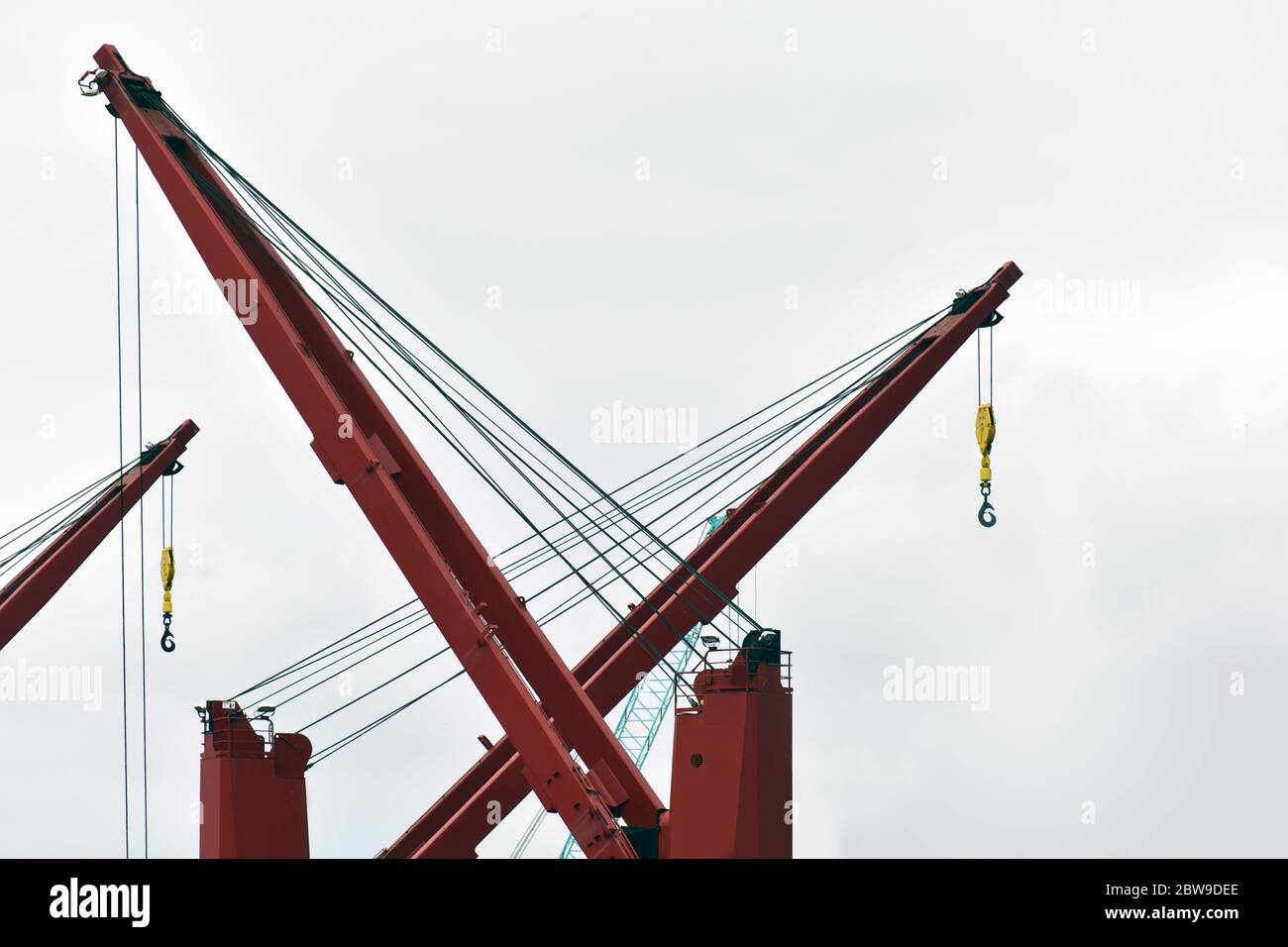 Cranes form a geometric backdrop at a wharf Stock Photo - Alamy