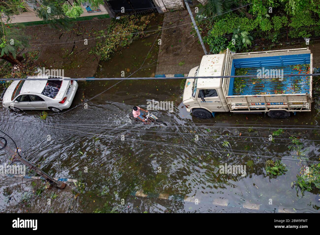 Aerial view of water logged city street with stranded vehicles after ...