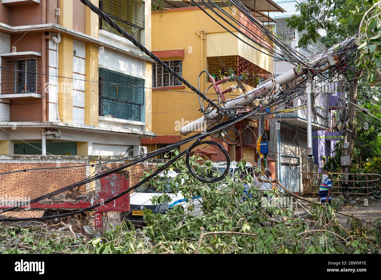 High tension electric wires hanging dangerously from a broken pole on a ...