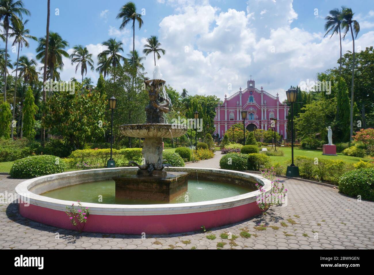 Fountain and pink Catholic church in Quezon, Philippines, Southeast ...