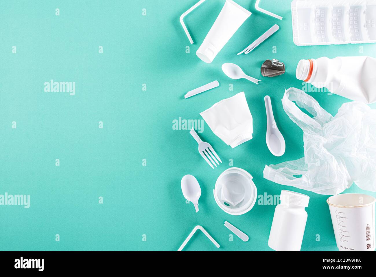 Top view of Different garbage materials on green pastel background ...