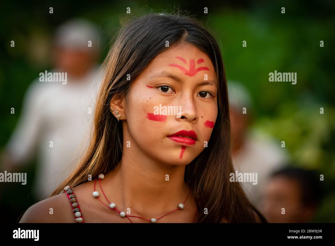 Peruvian girl dressed in traditional celebratory garb meets visitors ...