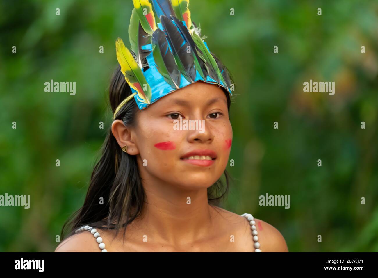 Peruvian girl dressed in traditional celebratory garb meets visitors ...