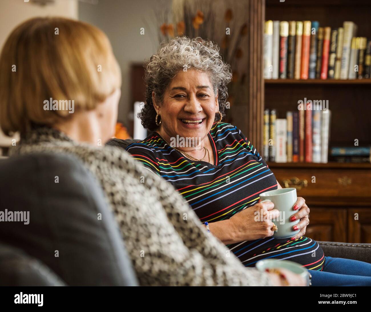 Senior women drinking tea and talking Stock Photo - Alamy