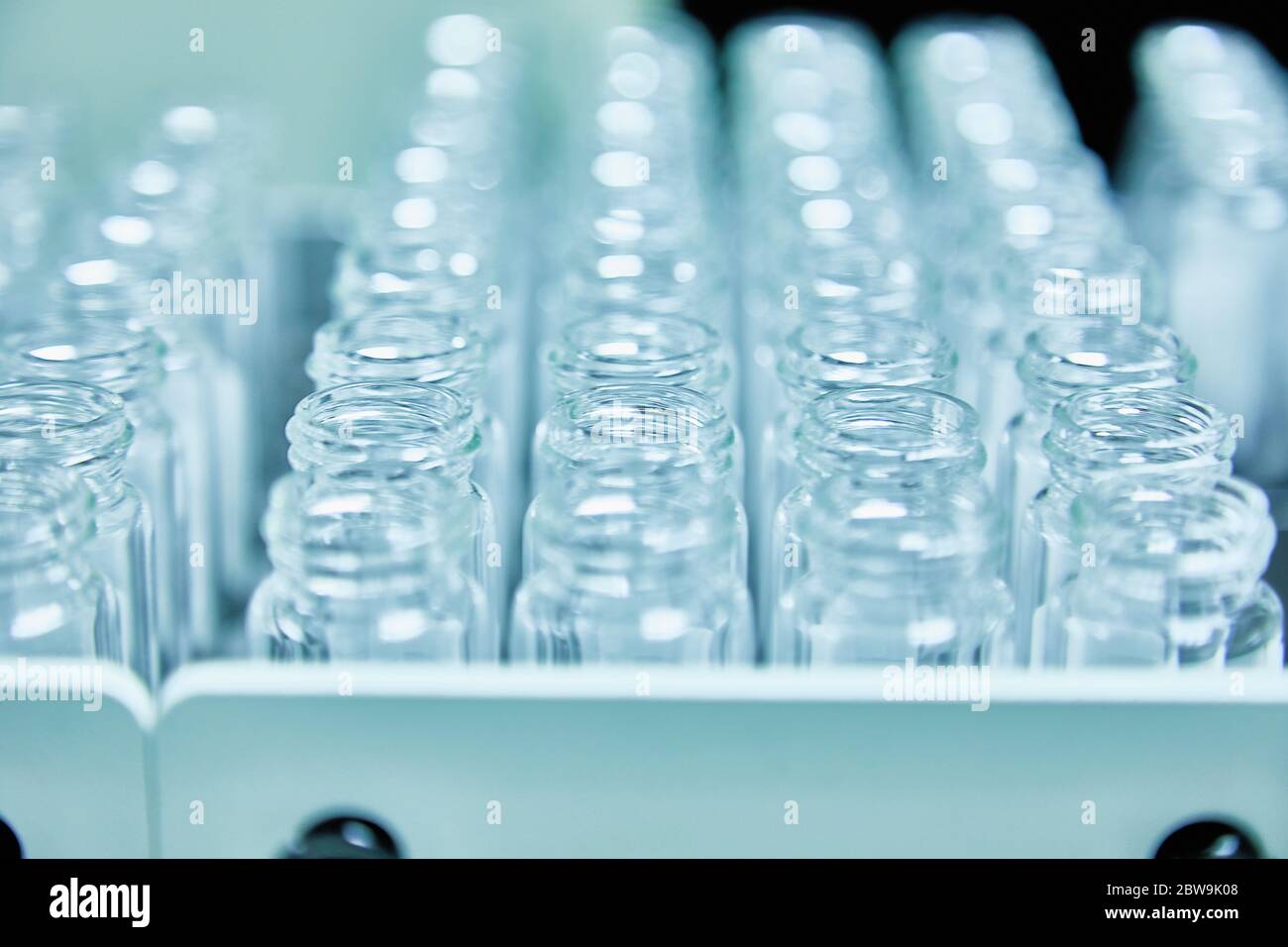 Bottles or test tubes in container Stock Photo - Alamy