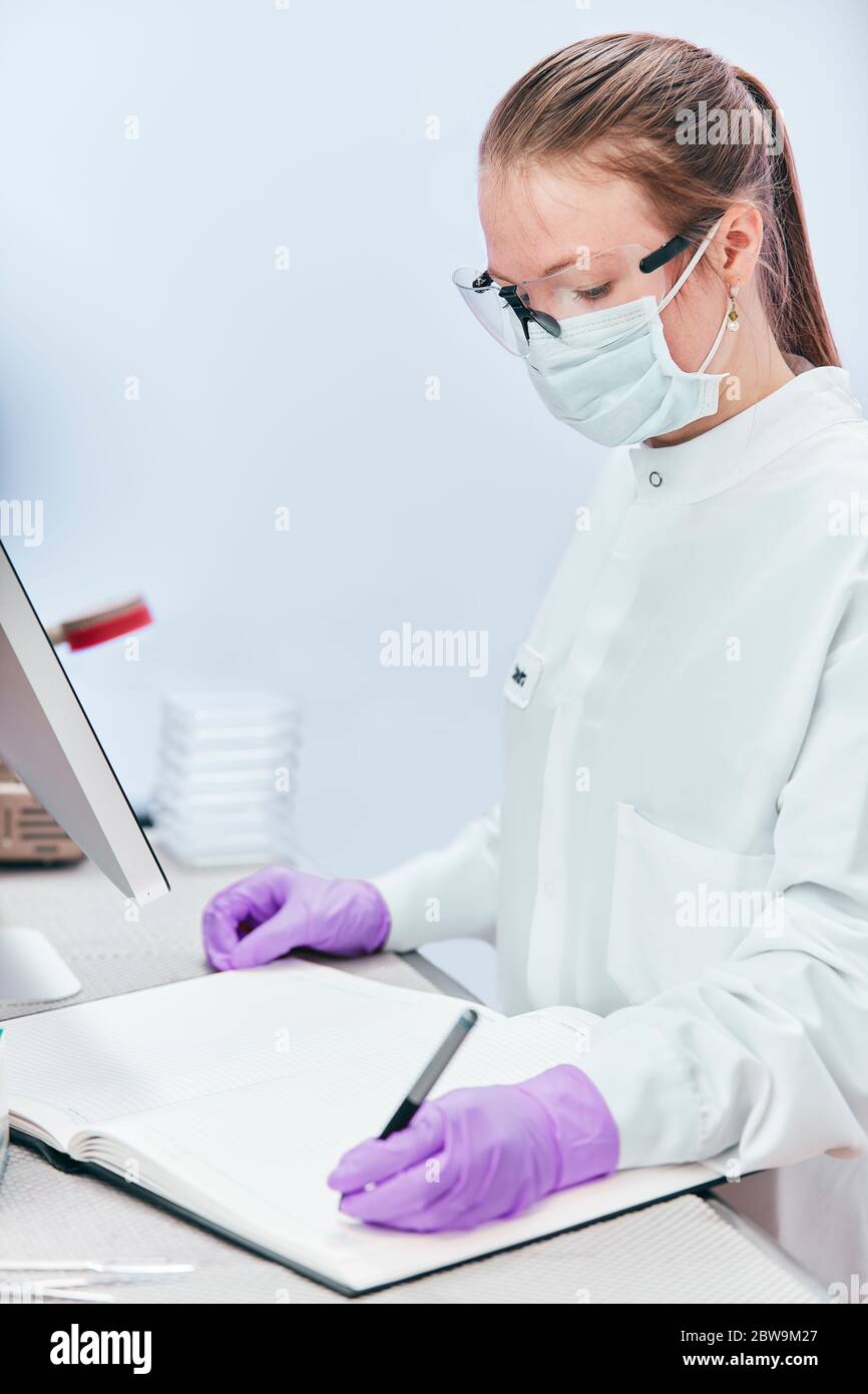 Female technician writing in notebook Stock Photo - Alamy