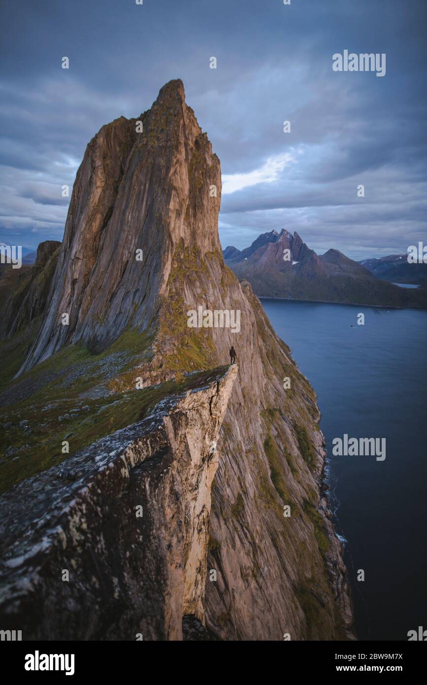 Norway, Senja, Man standing on cliff edge nearÂ SeglaÂ mountain Stock ...