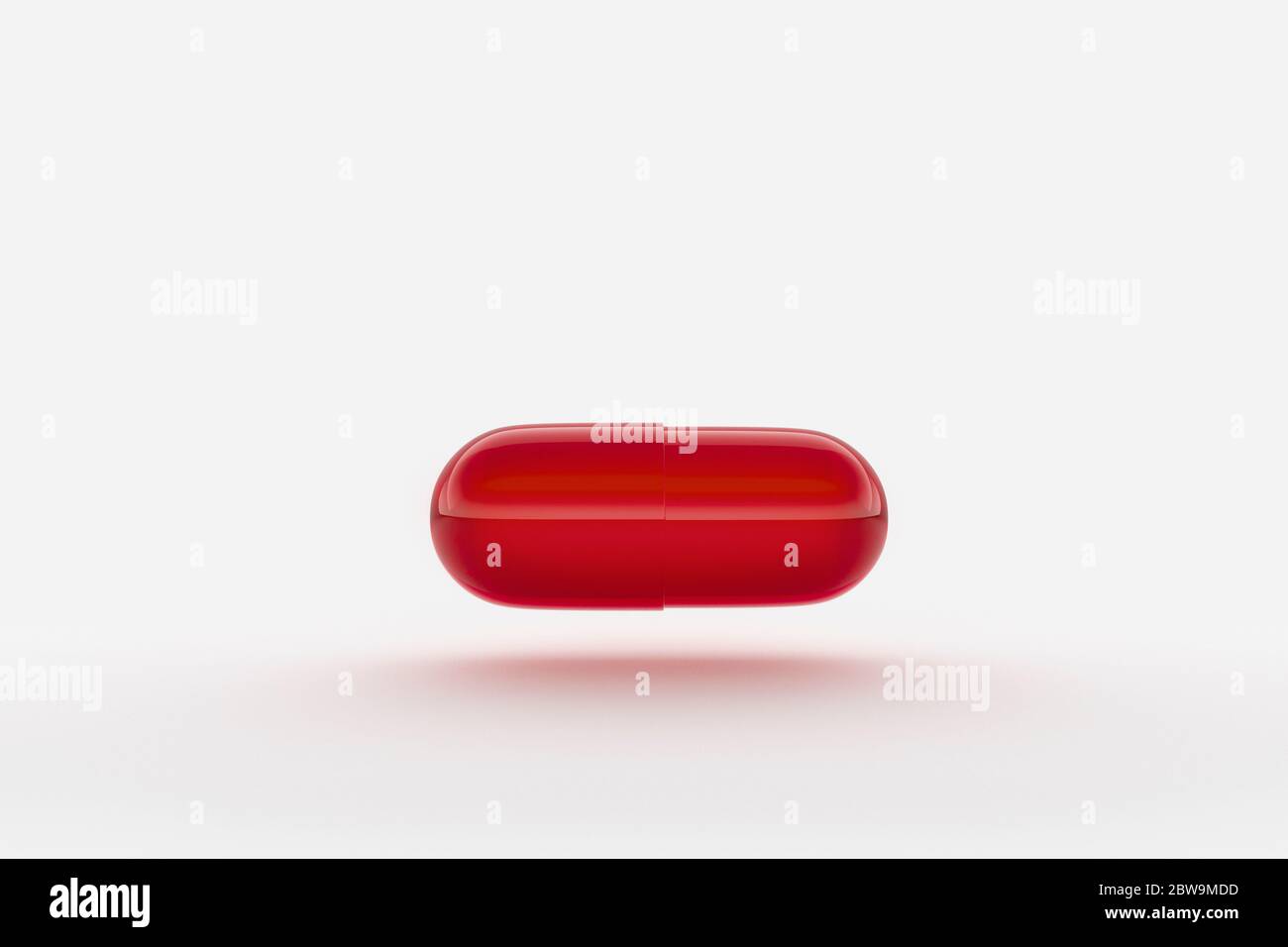 Studio shot of red capsule Stock Photo - Alamy