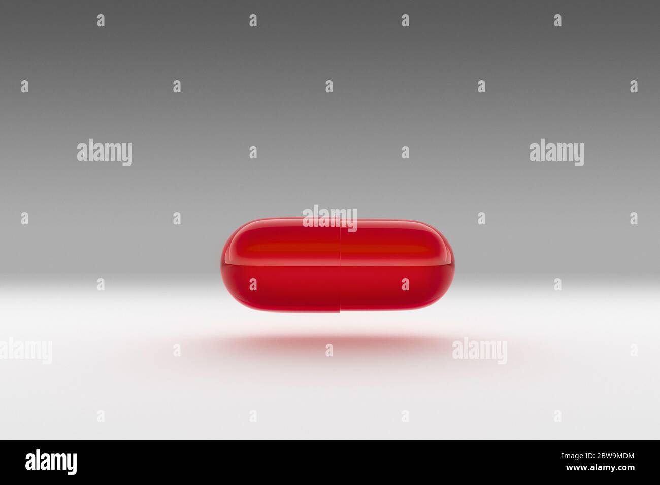 Studio shot of red capsule Stock Photo - Alamy