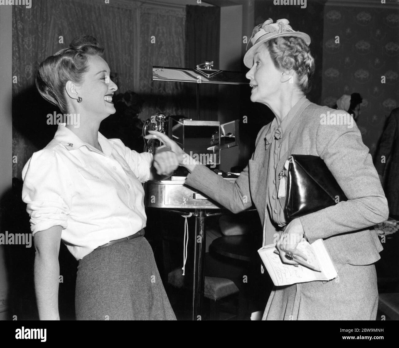 BETTE DAVIS and visiting Newspaper Gossip Columnist HEDDA HOPPER on set ...