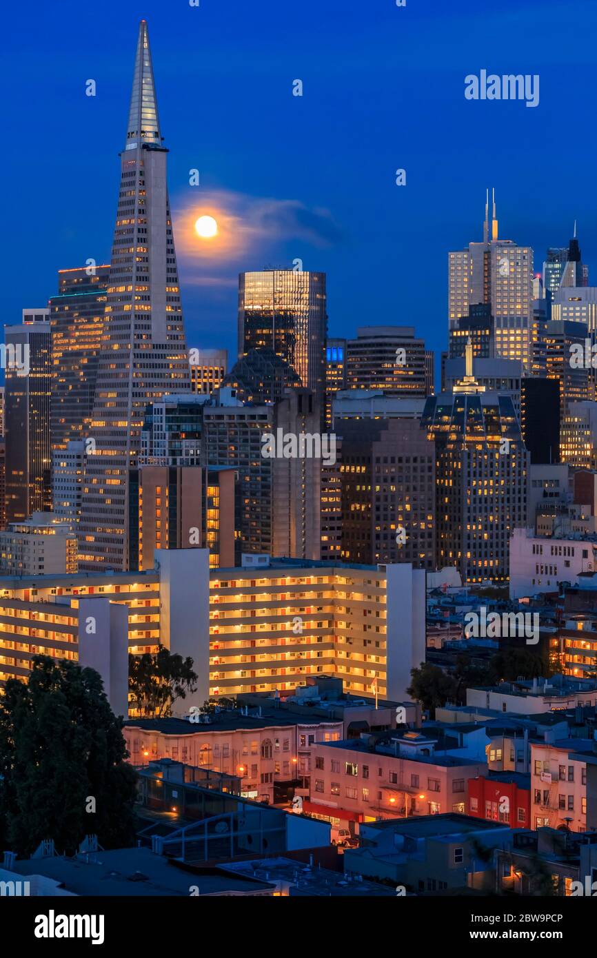 San Francisco downtown skyline at sunset with the full moon between the ...