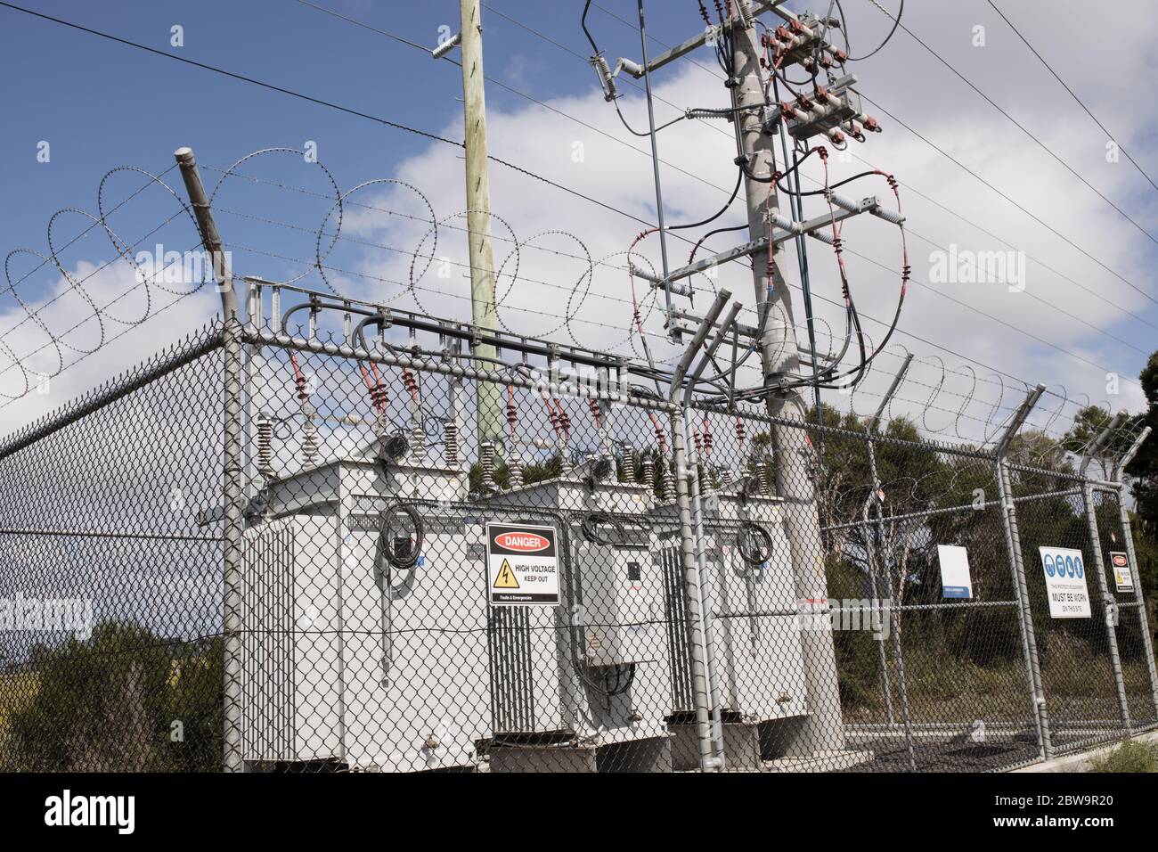 High voltage electricity substation surrounded by fence outside ...