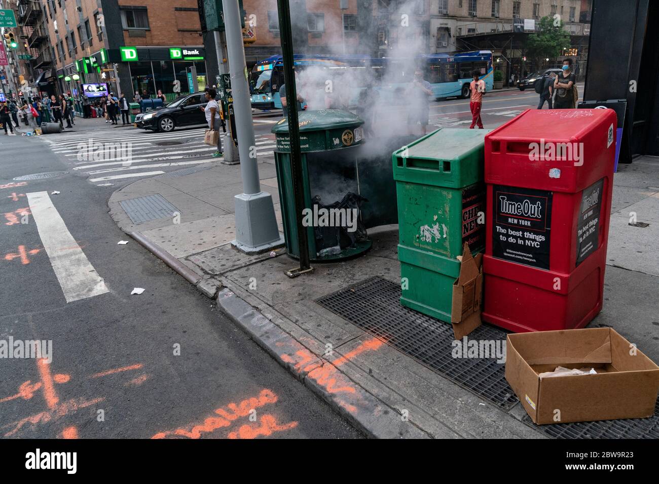 New York, NY - May 30, 2020: Protesters set fire on garbage recepticle ...