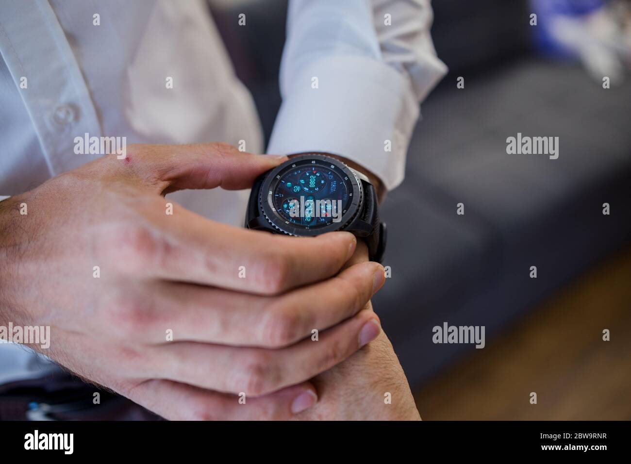 man puts smart watch on his hand Stock Photo - Alamy