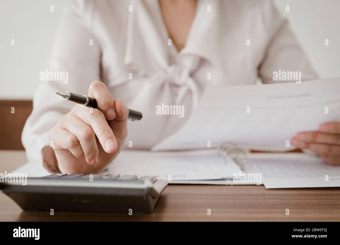 Accountant check the numbers on the balance sheet. Concept of ...