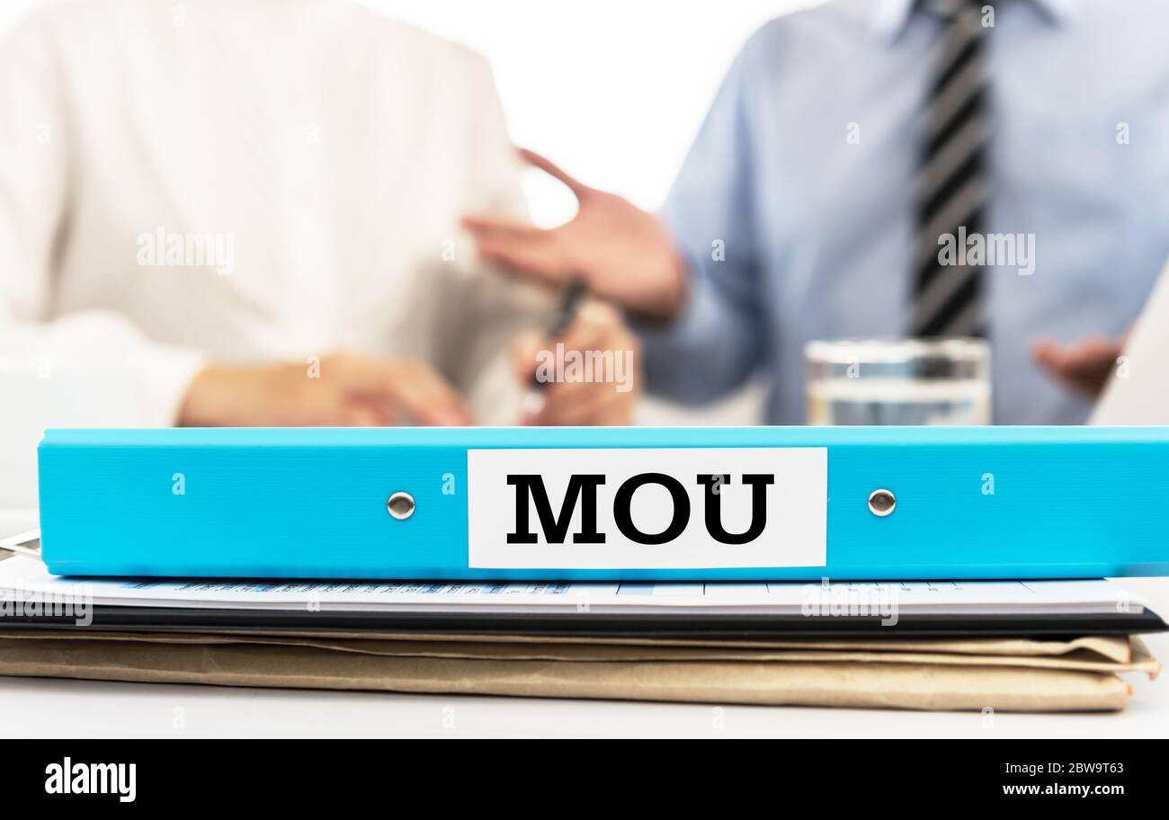 MOU, memorandum of understanding document folder on desk in meeting ...