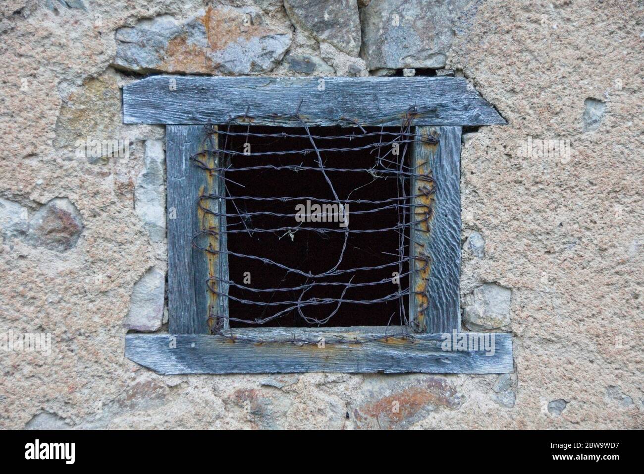 Window covered with barbed wire Stock Photo - Alamy