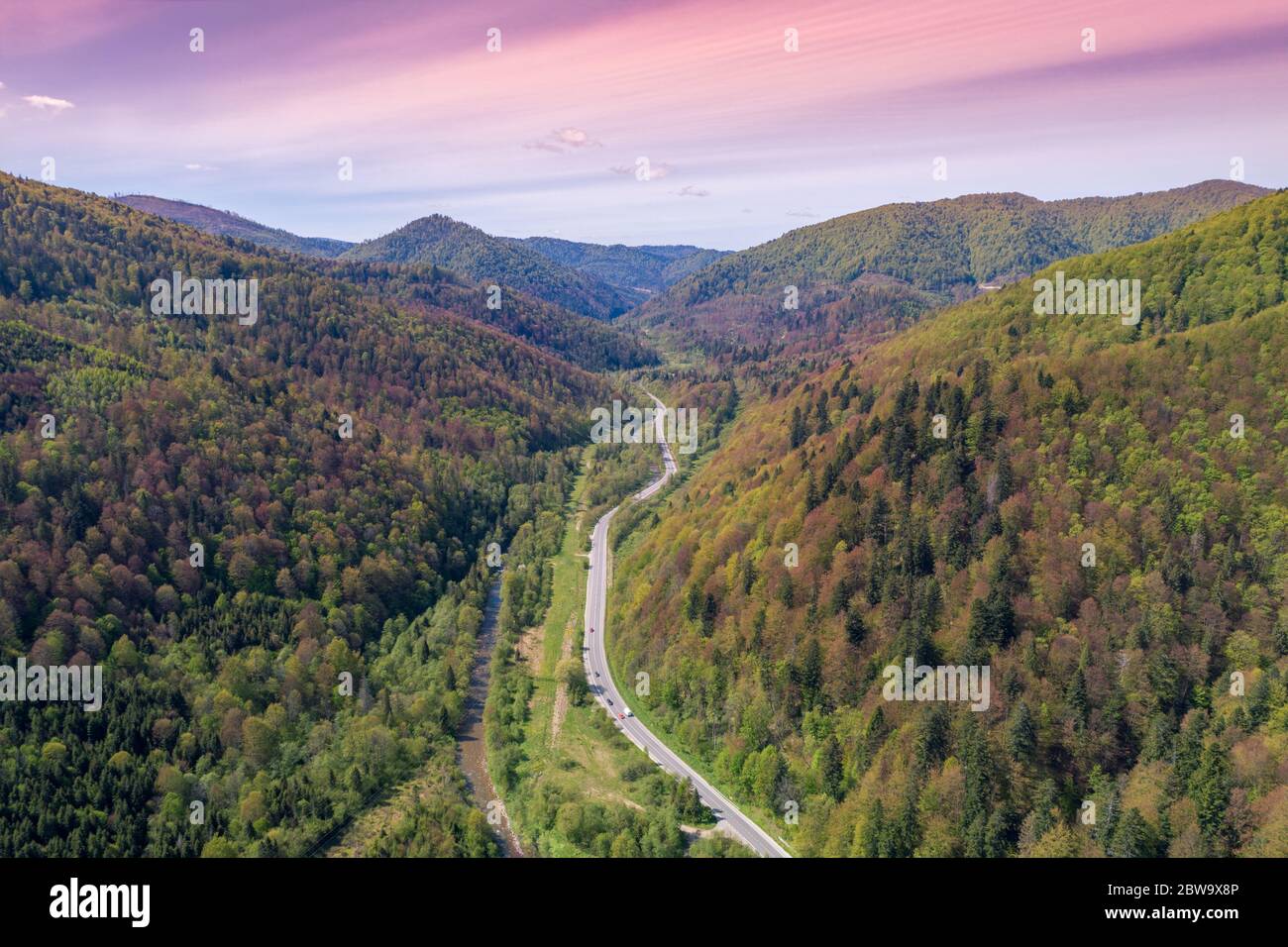 Aerial view of the mountains and valley with highway in spring ...