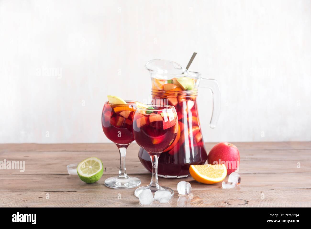 Red Wine Sangria in pitcher and glasses on wooden table, copy space ...