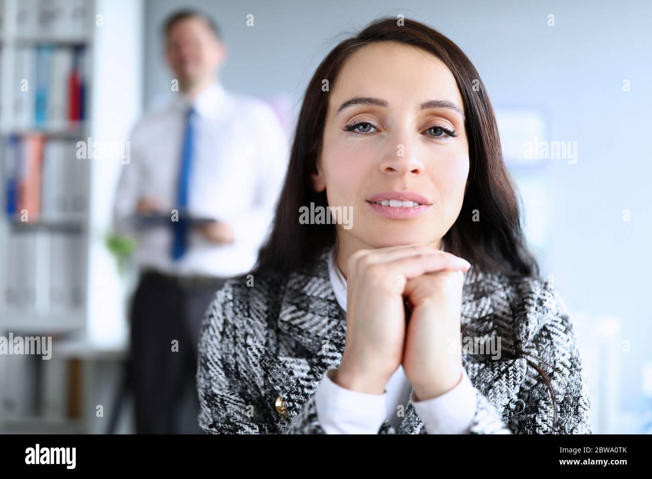 Beautiful woman boss in suit sitting in office Stock Photo - Alamy
