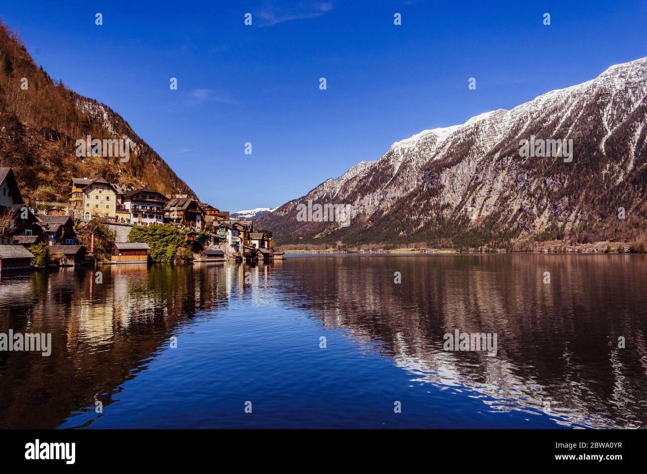 Hallstatt view from the lake with snow covered mountains on the ...