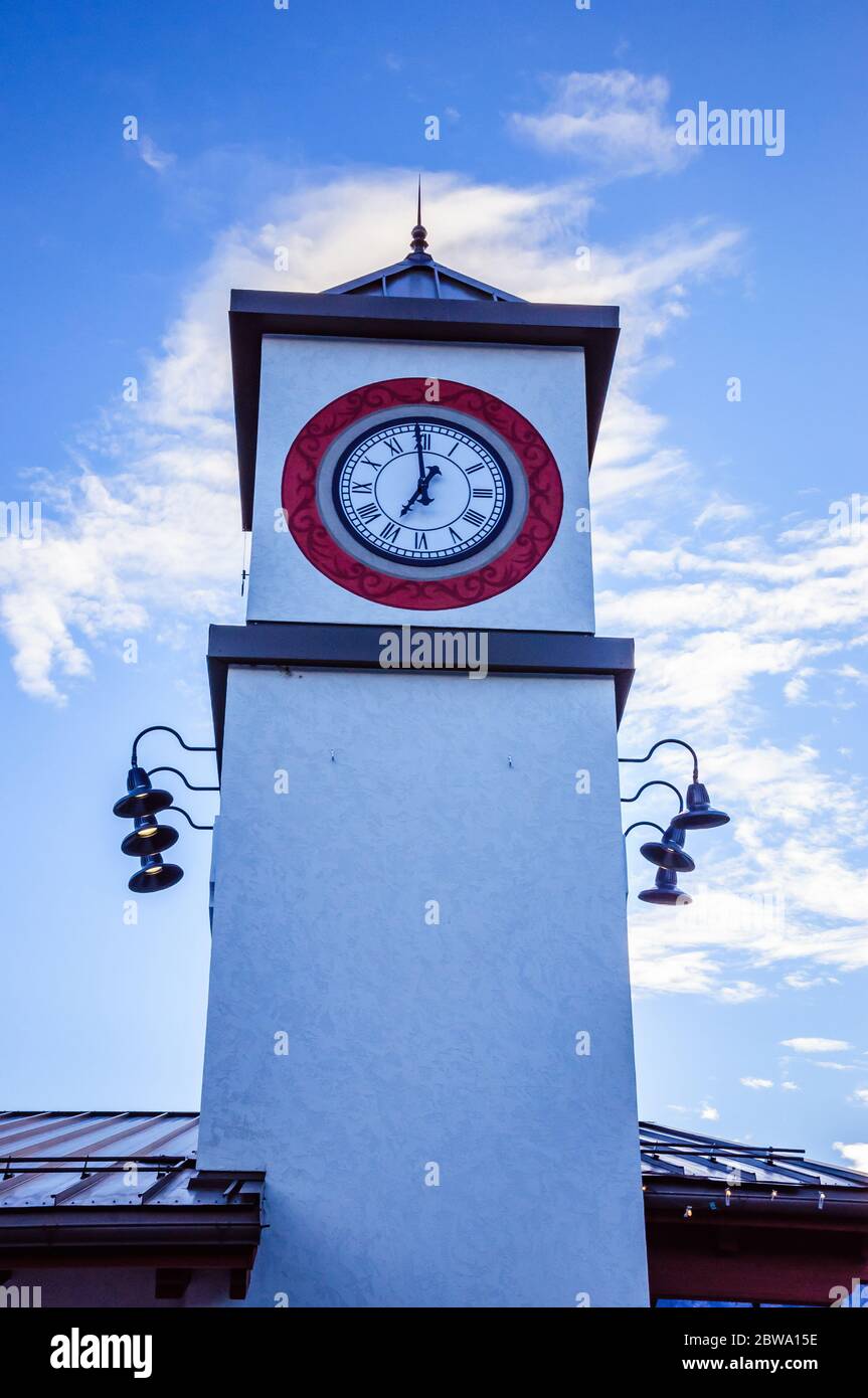 Clock tower with blue cloudy sky on the background Stock Photo - Alamy