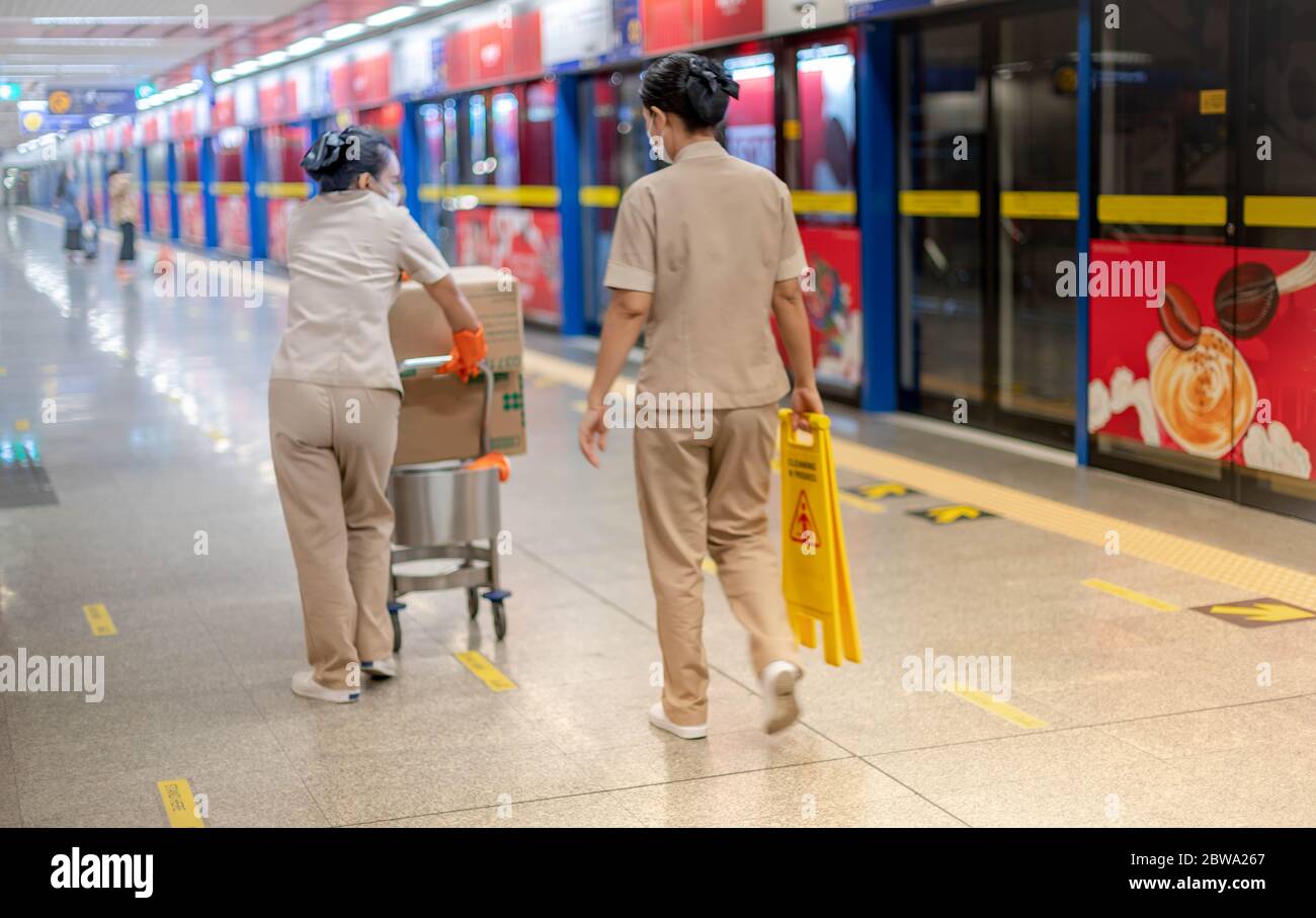The two maid wearing surgical mask and cleaning glove preparing to big ...
