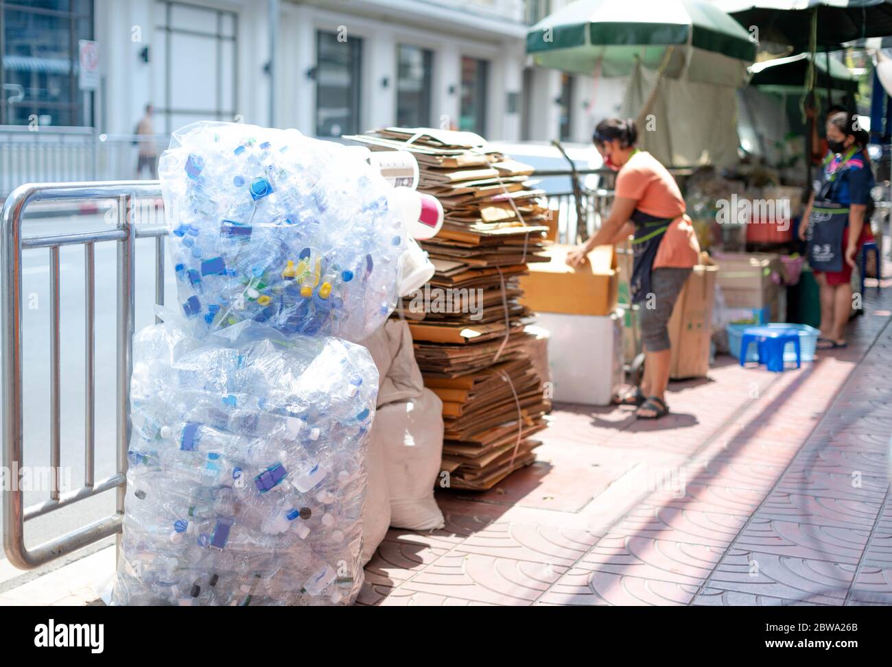A pile of flatten cardboard boxes on the trolley cart and pile of ...