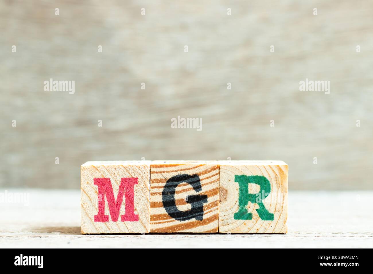 Alphabet letter in word mgr (abbreviation of manager) on wood ...