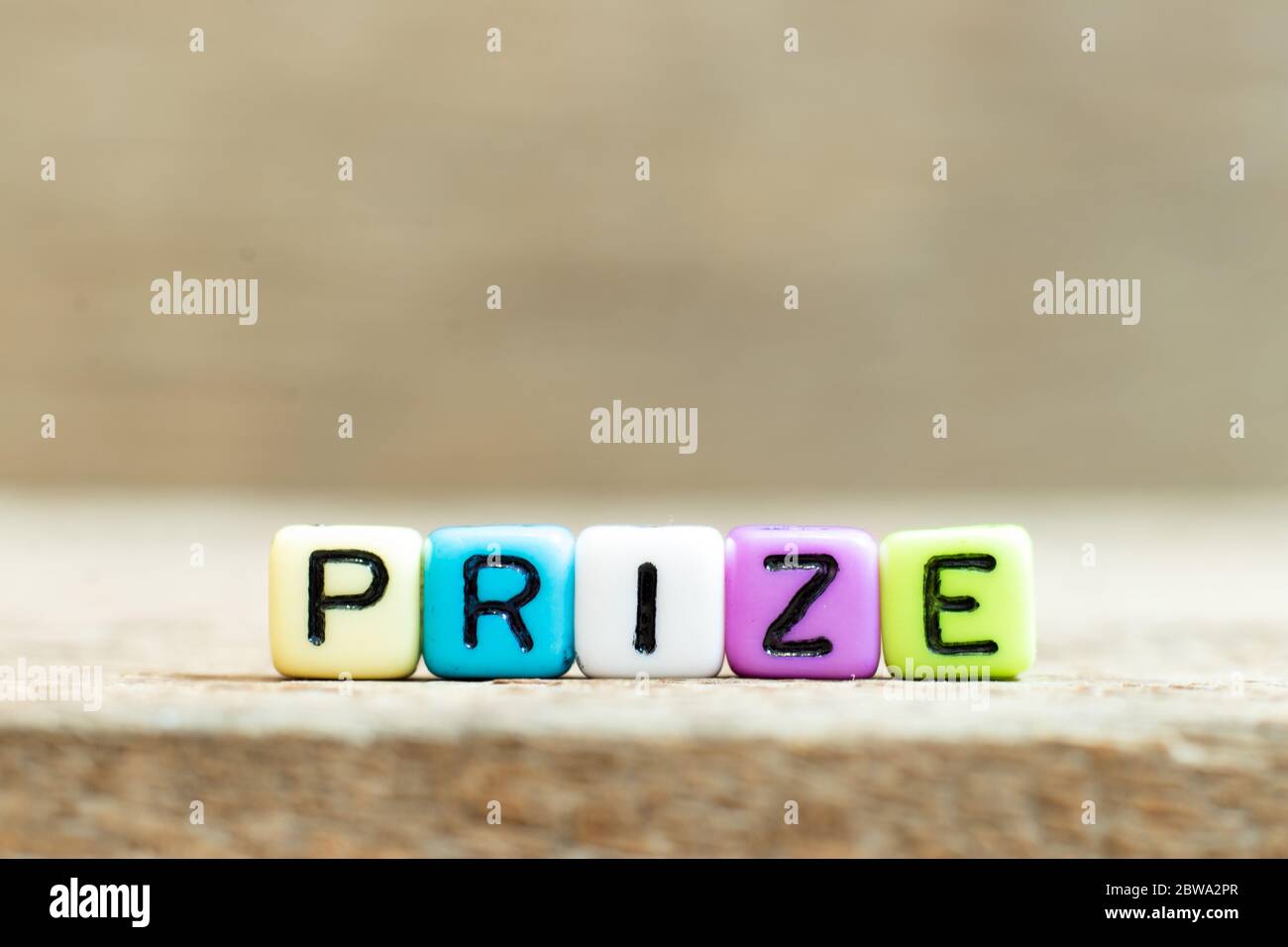 Colorful bead with black letter in word prize on wood background Stock ...