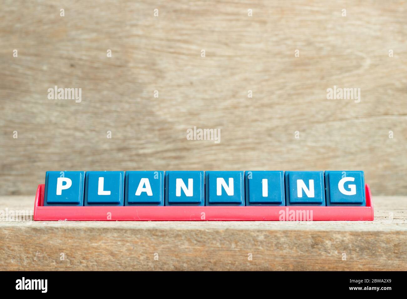 Tile letter on red rack in word planning on wood background Stock Photo ...