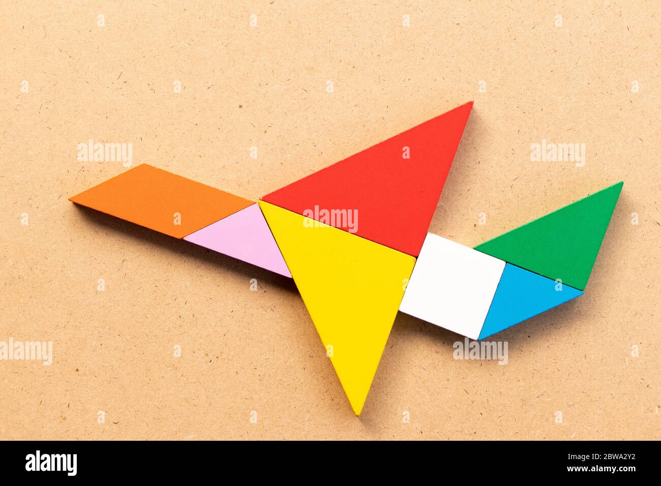 Color tangram puzzle in airplane shape on wood bacground Stock Photo ...