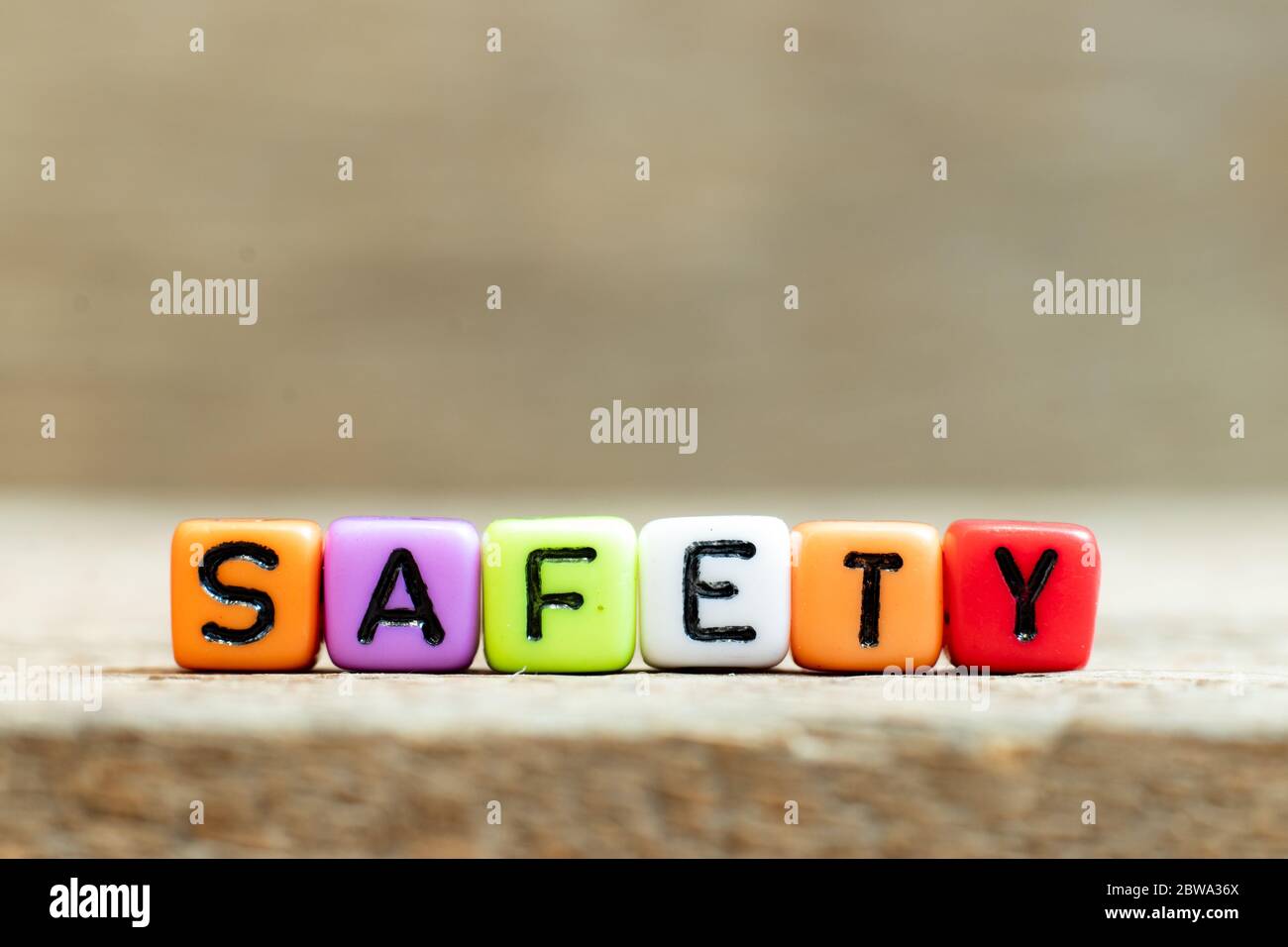 Colorful bead with black letter in word safety on wood background Stock ...