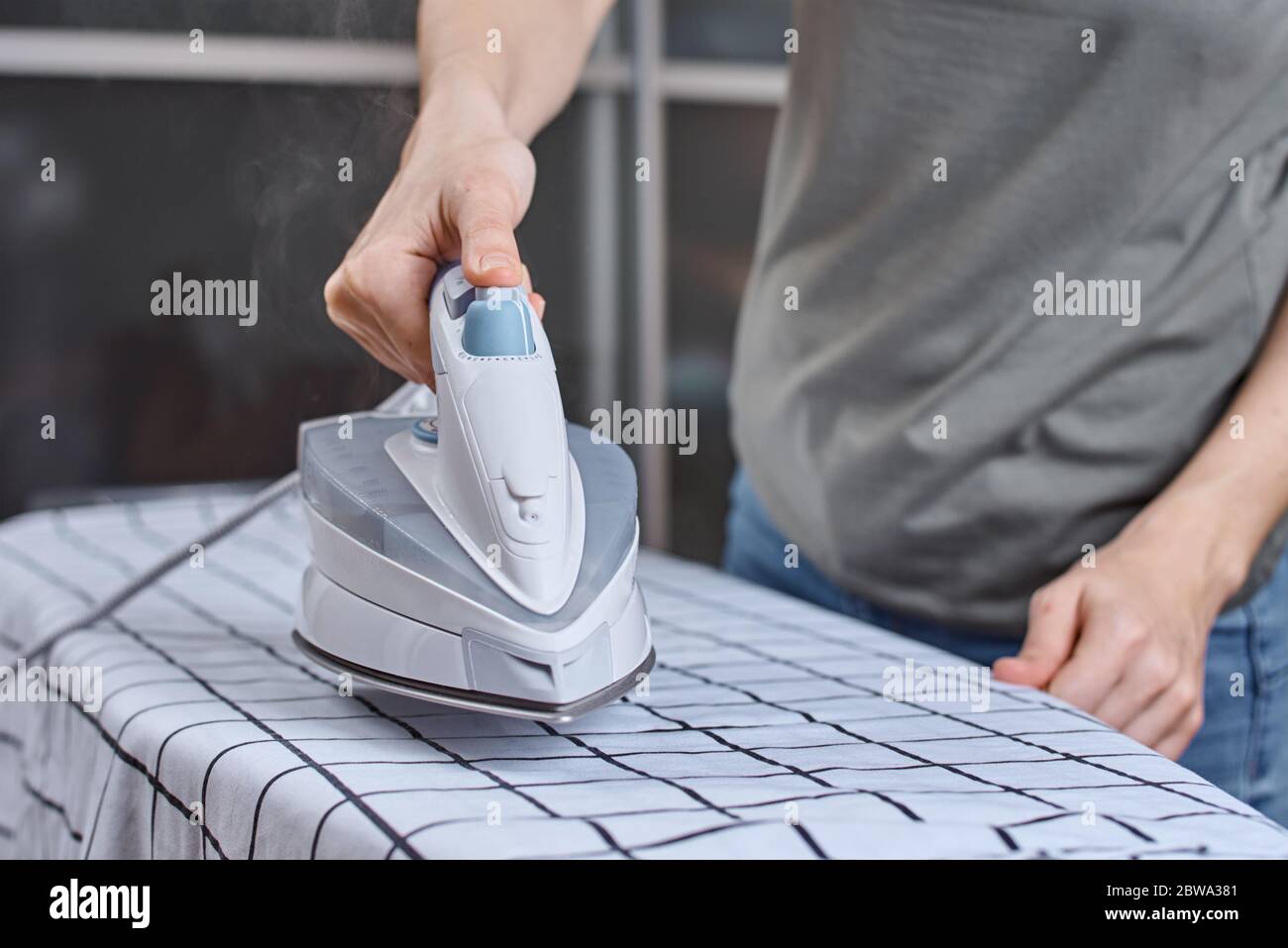 Hand ironing clothes using electric hi-res stock photography and images ...