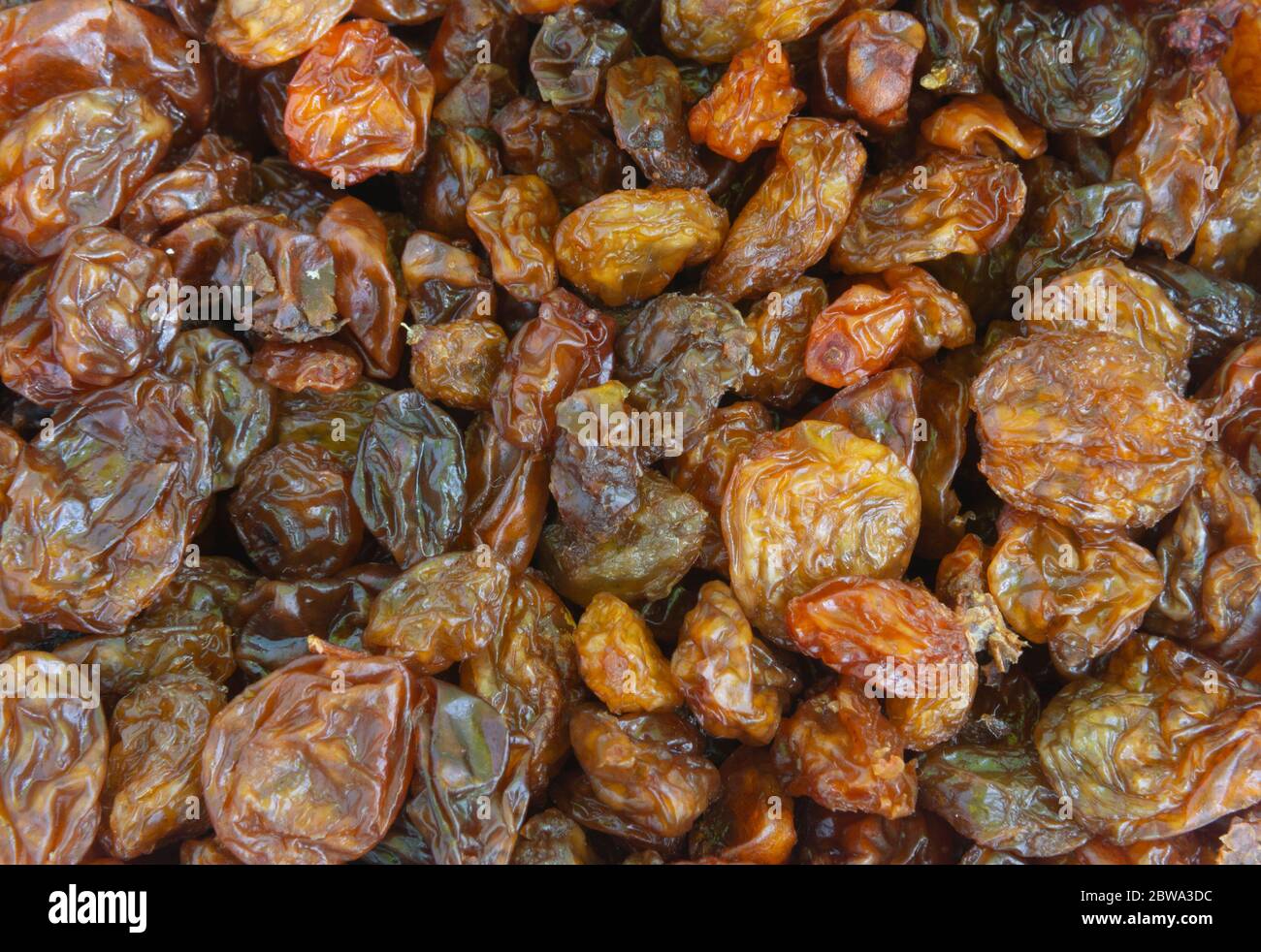 Raisins as abstract background texture, dark and colored, closeup top ...