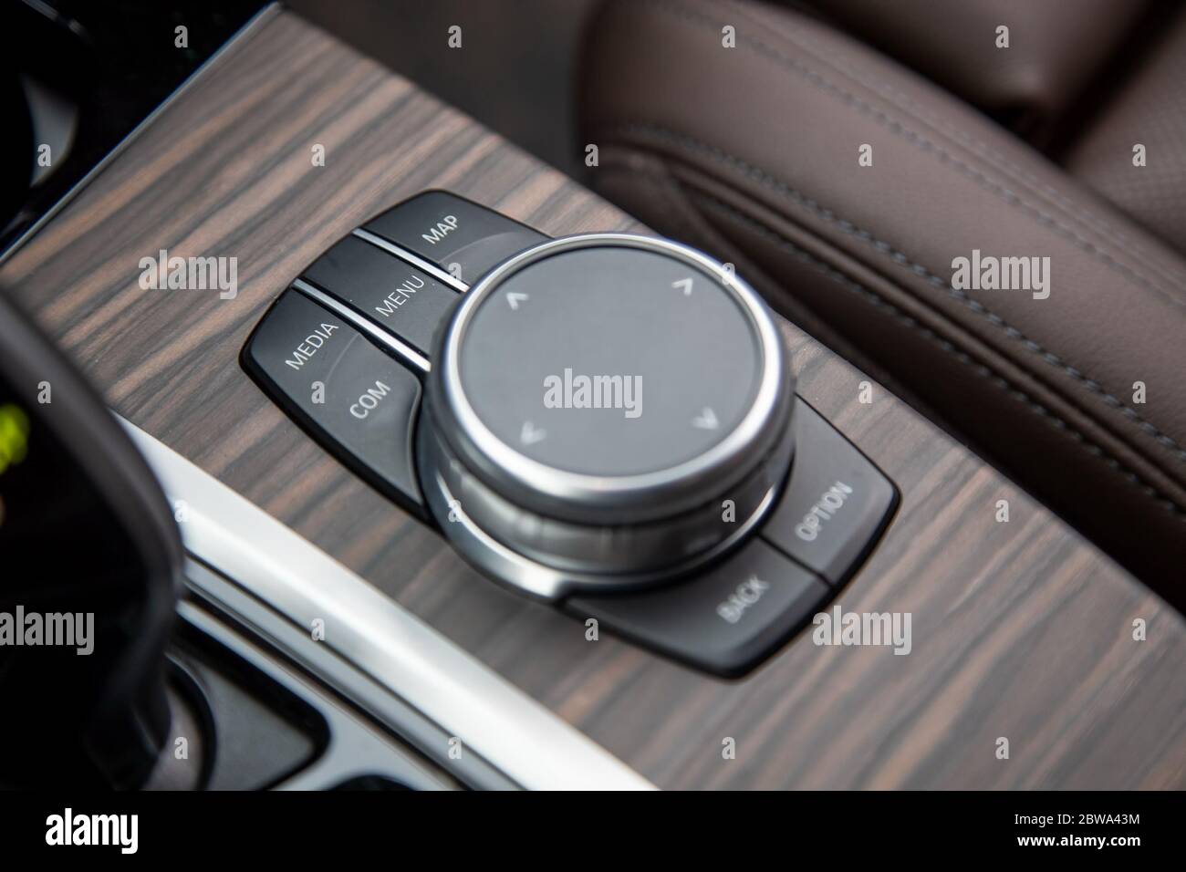Closeup of multimedia system control buttons on a wood panel in a ...