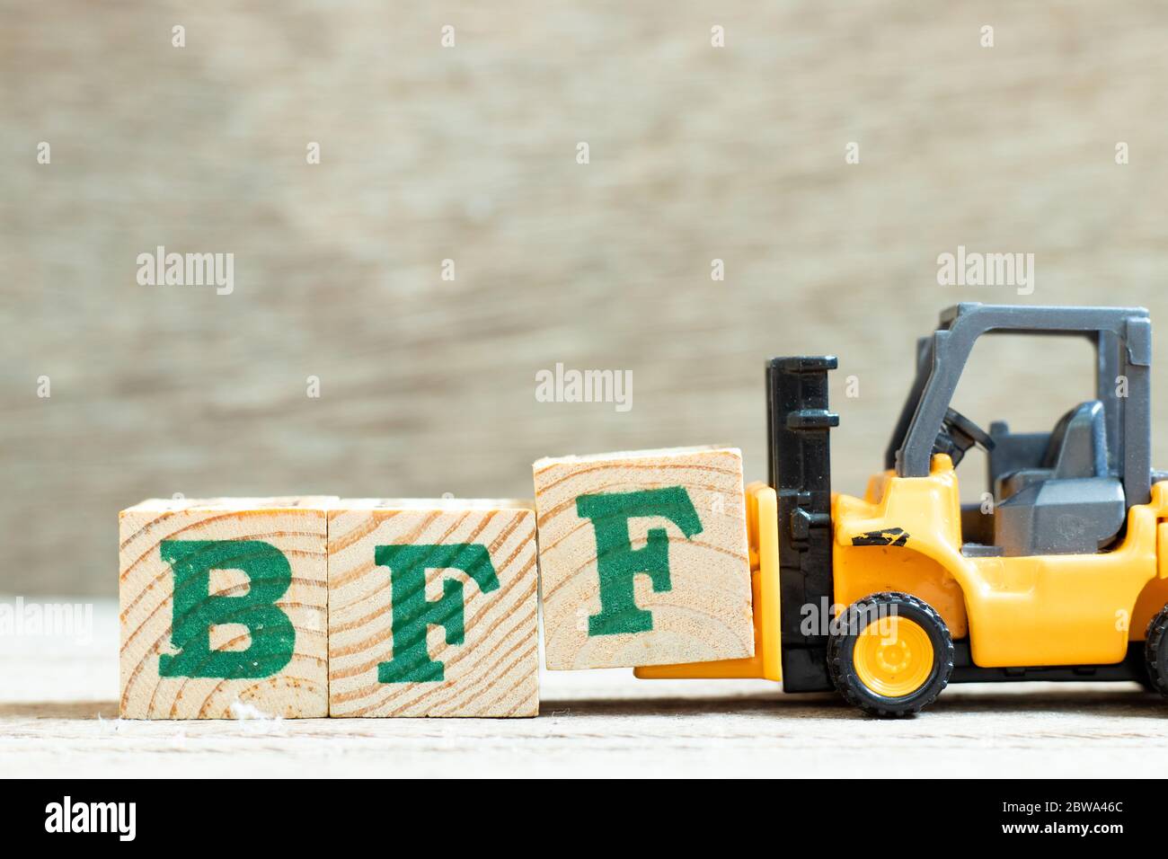 Toy forklift hold letter block f to complete word BFF (Abbreviation of ...