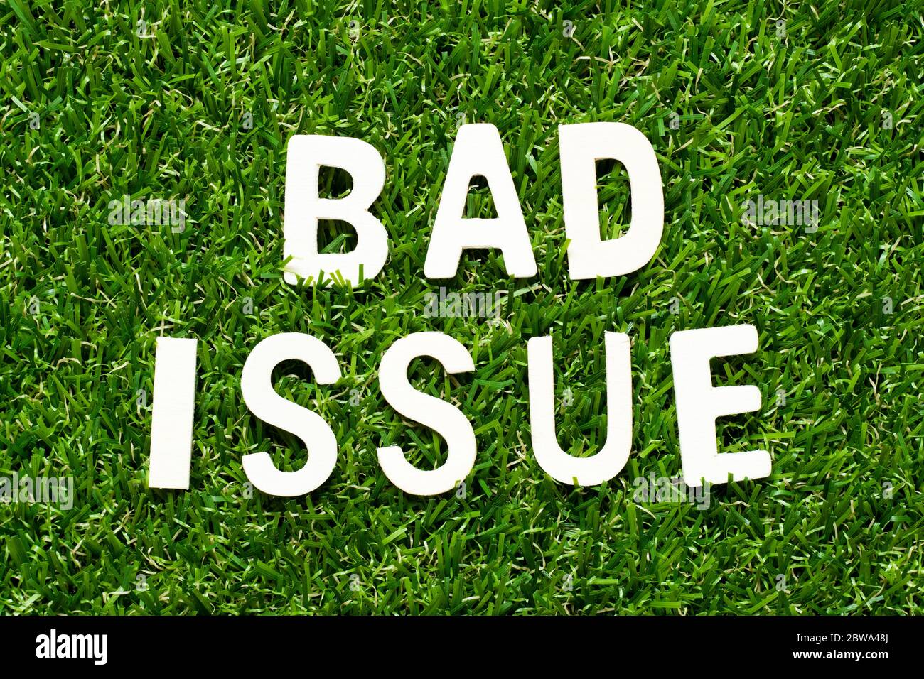 Wood alphabet letter in word bad issue on green grass background Stock ...