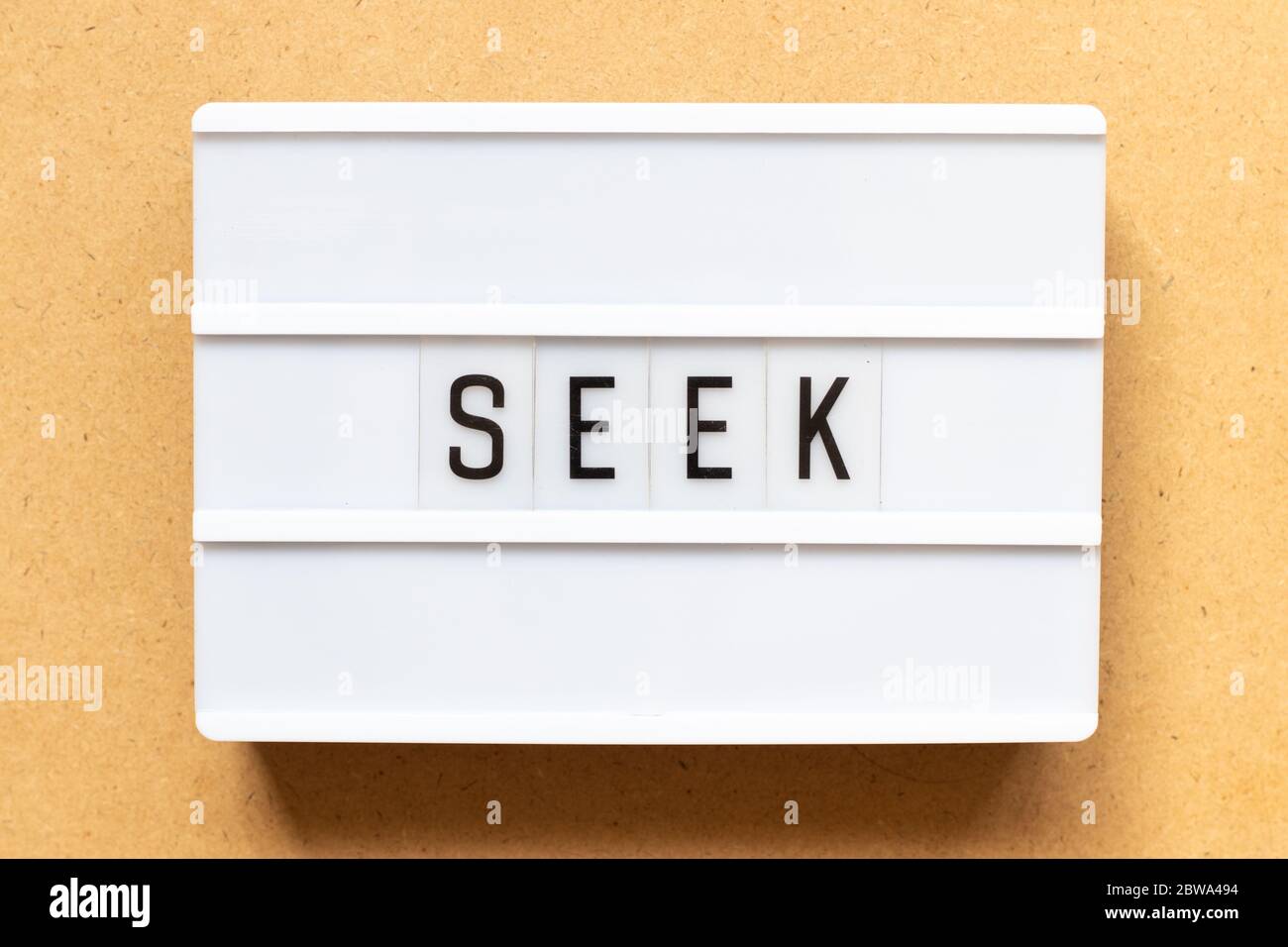 Lightbox with word seek on wood background Stock Photo - Alamy