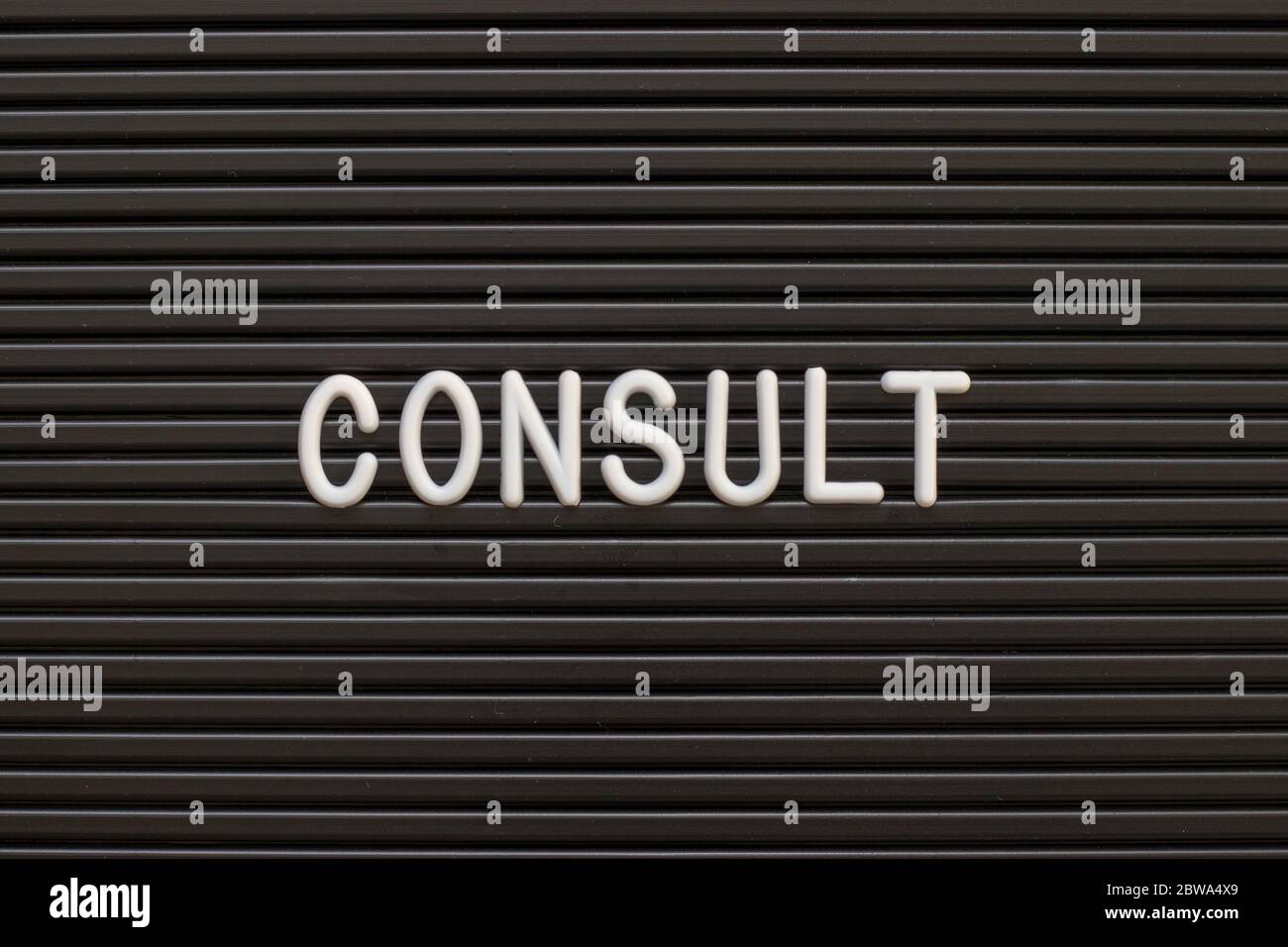 Black color felt letter board with white alphabet in word consult ...