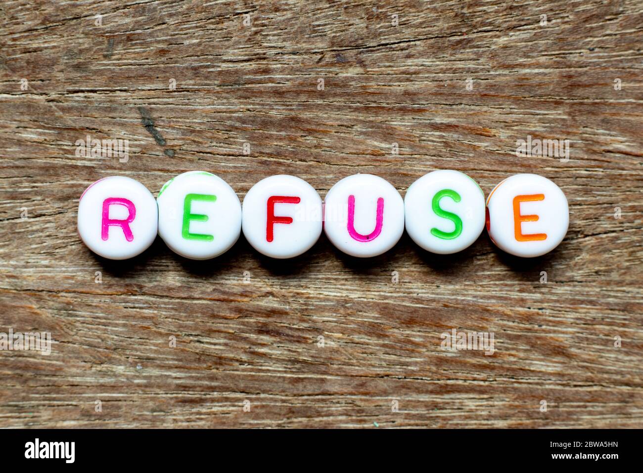 White bead with color letter in word refuse on wood background Stock ...