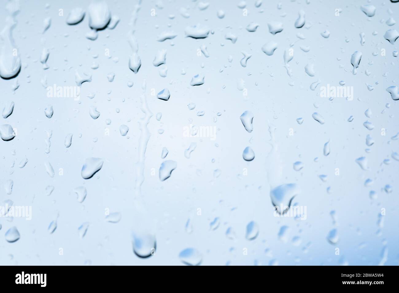 Rain drops on window with out of focus elements Stock Photo - Alamy
