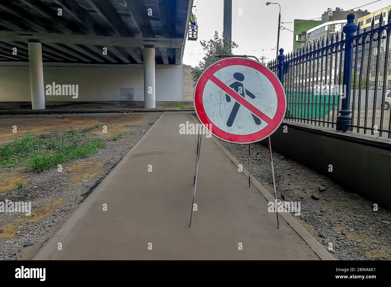 The sign the passage is forbidden on poles stands on a pedestrian paved ...