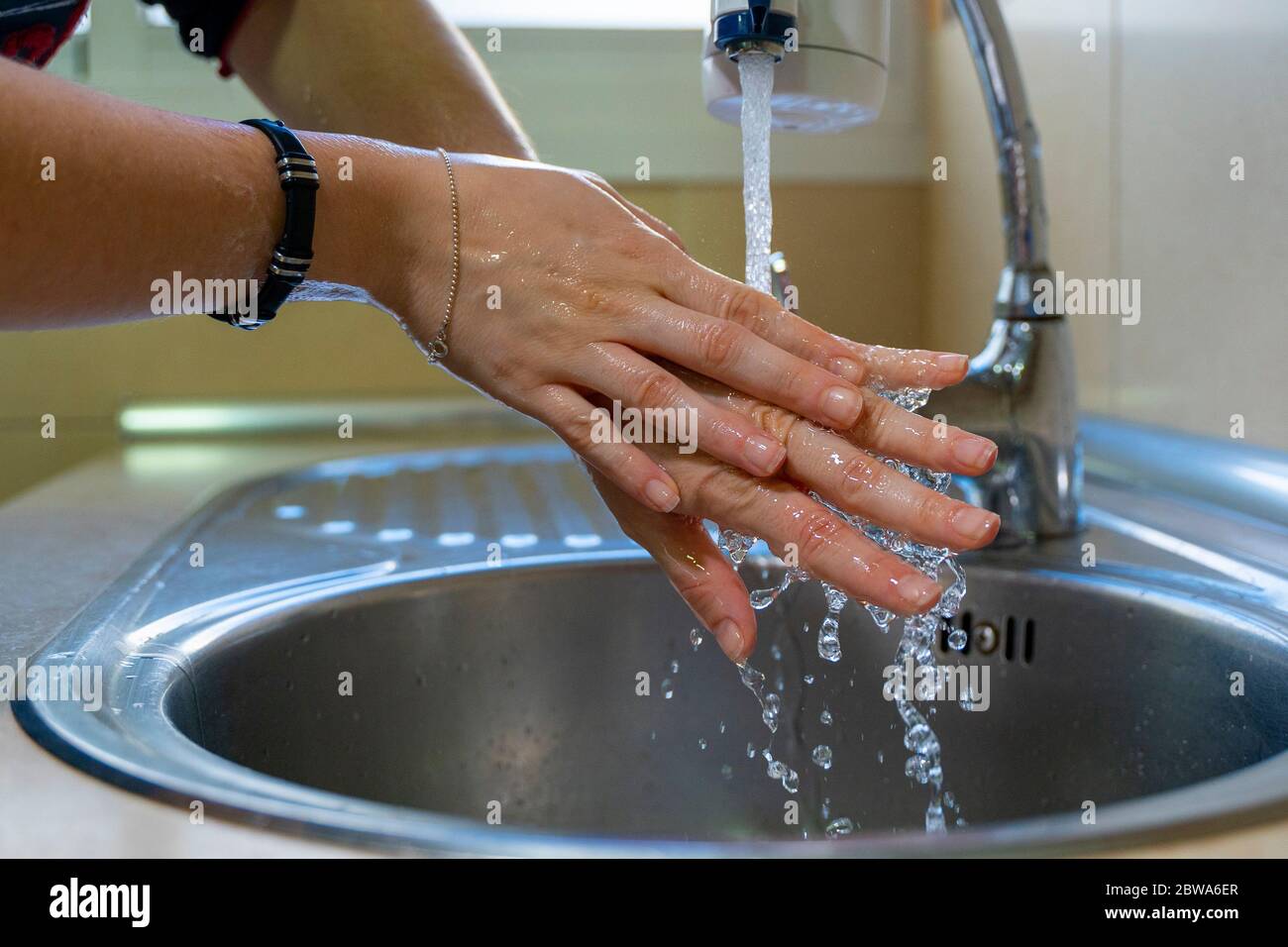 Washing hands properly. Hygiene concept. Rubbing back of hand with ...